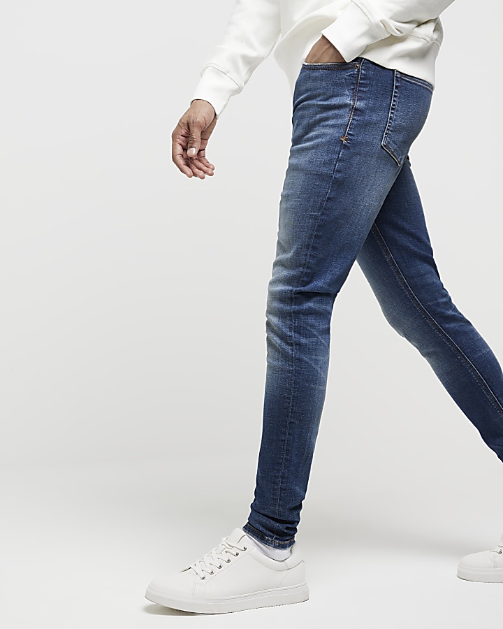 Blue super skinny spray on jeans | River Island